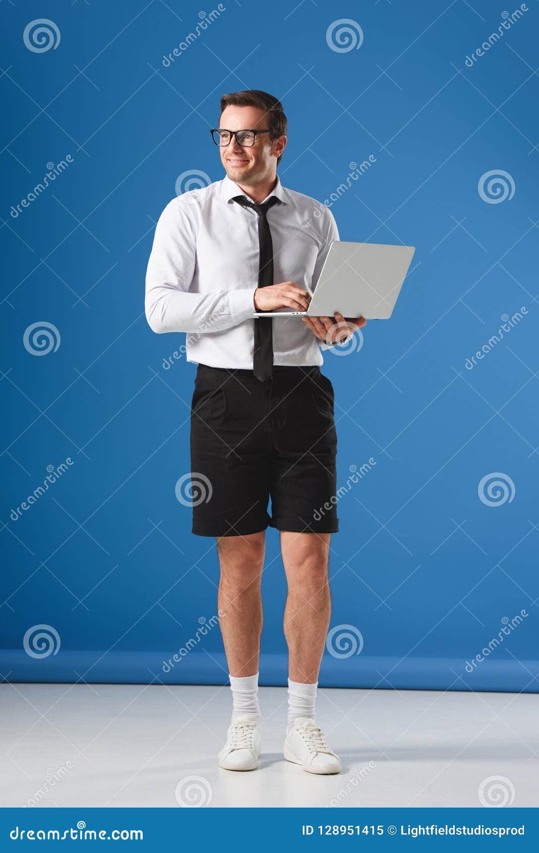 Handsome Smiling Businessman in Shorts Using Laptop and Looking Away ...