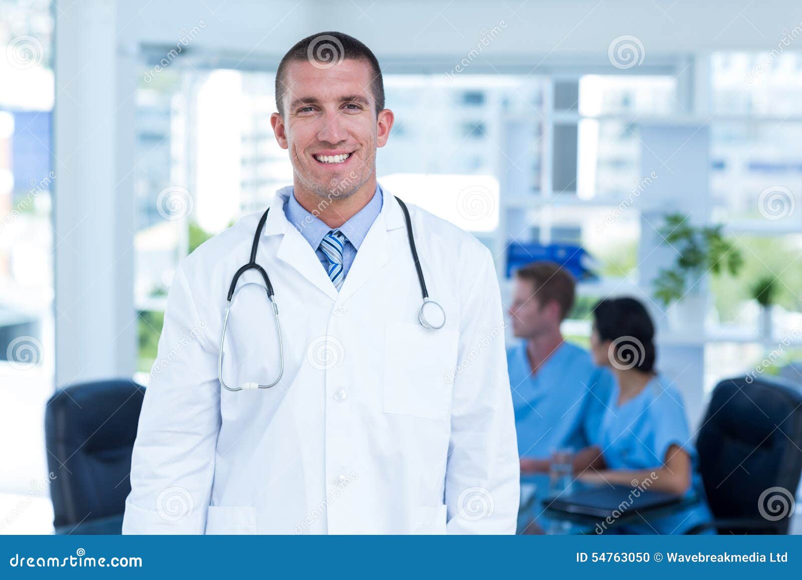 Handsome Smiling Doctor Looking at Camera Stock Photo - Image of doctor ...