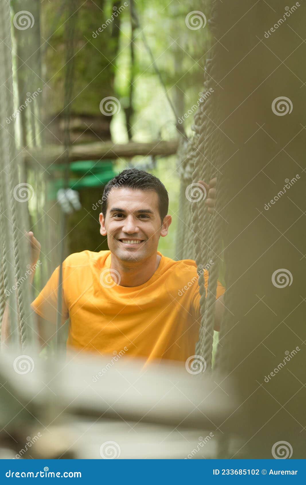 Handsome Smiling Man Crossing Rope Bridge Stock Photo - Image of ...