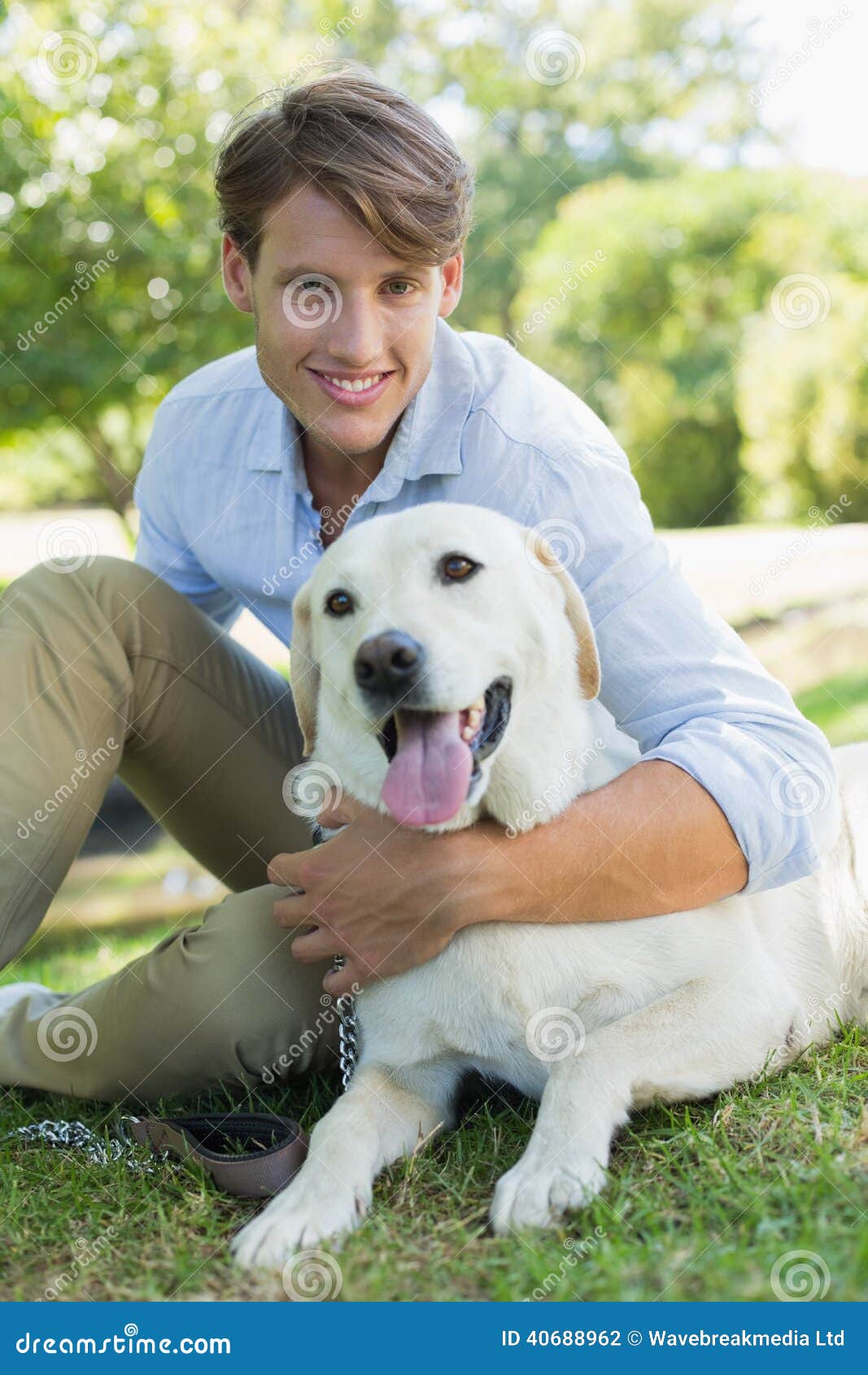 Handsome Smiling Man with His Labrador Sitting in the Park Stock Photo ...