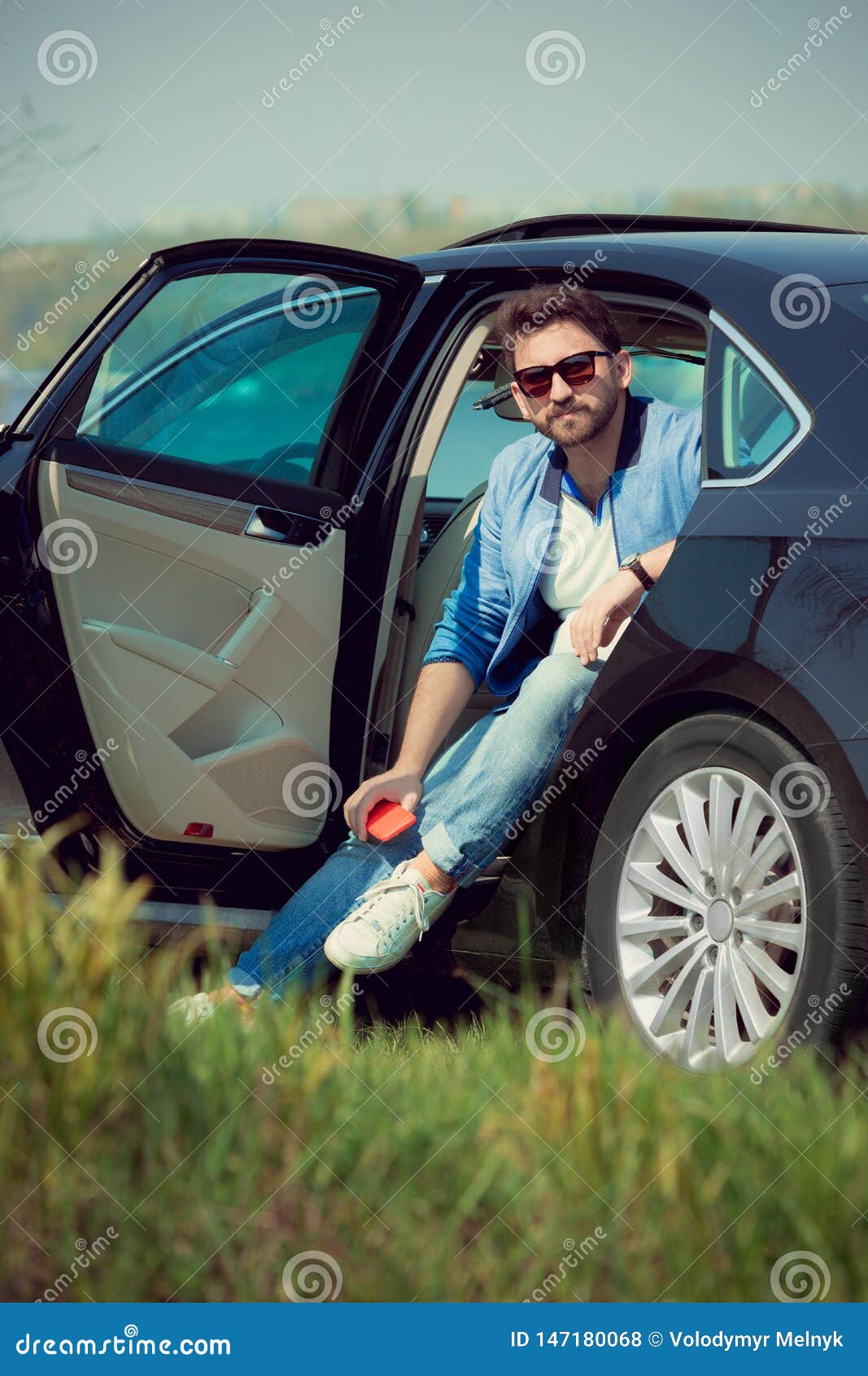 Handsome Smiling Man Sitting in His Car with Opened Doors Stock Photo ... Handsome Smiling Man Sitting in His Car with Opened Doors Stock Photo ...