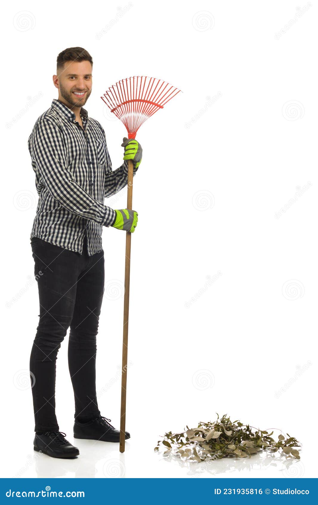 Handsome Smiling Man is Standing with a Leaf Rake. Full Length Studio ...