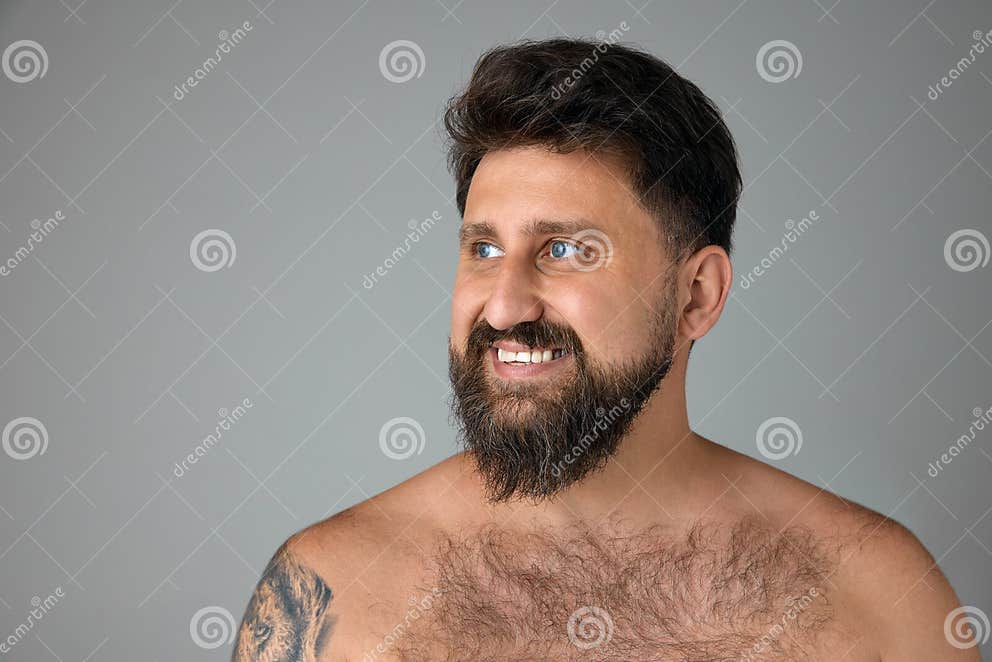 Handsome Smiling Mature Bearded Man With Blue Eyes Standing