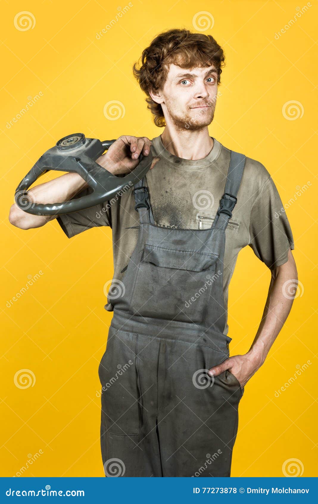 Handsome Smiling Mechanic with Wheel Yellow Vertical Stock Photo ...