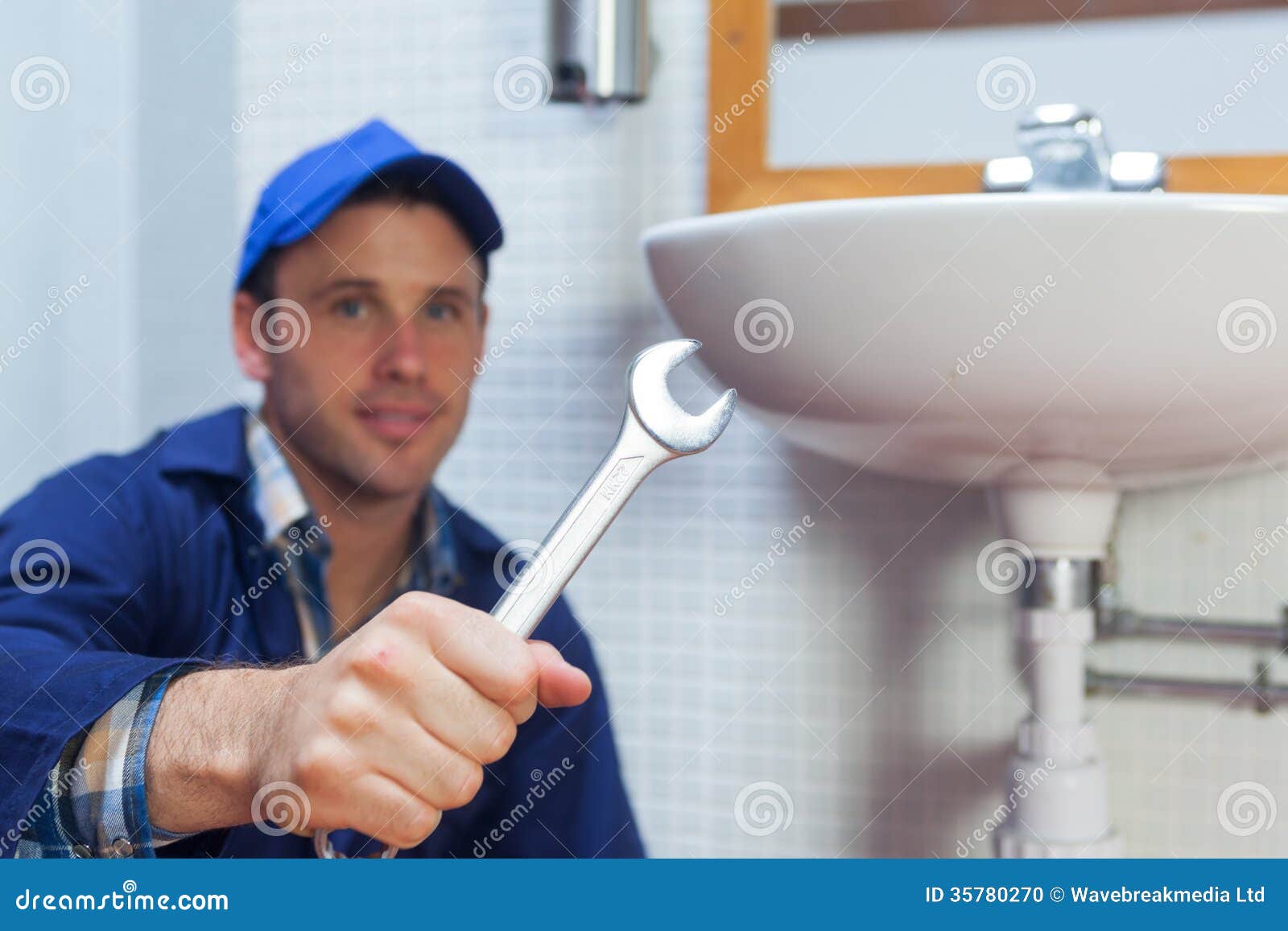 Handsome Smiling Plumber Showing Wrench Stock Photo - Image of ...