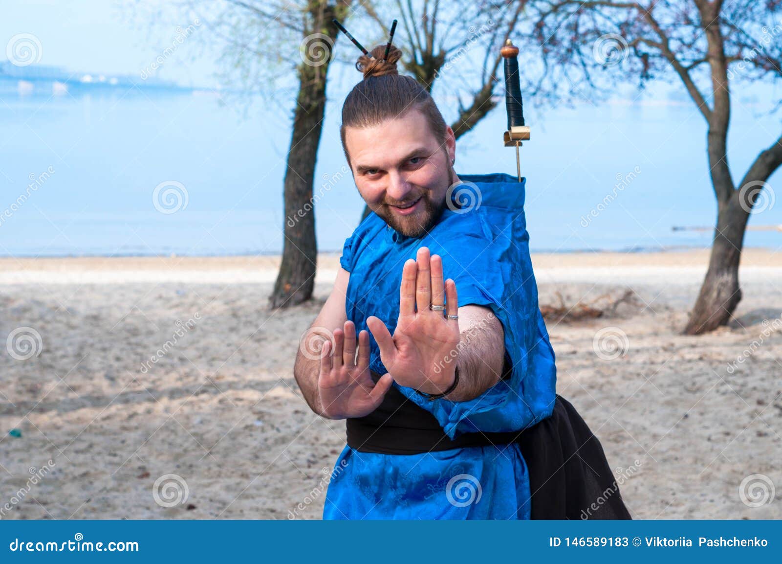Handsome Smiling Samurai in Blue Kimono, Bun and Sticks on Head ...
