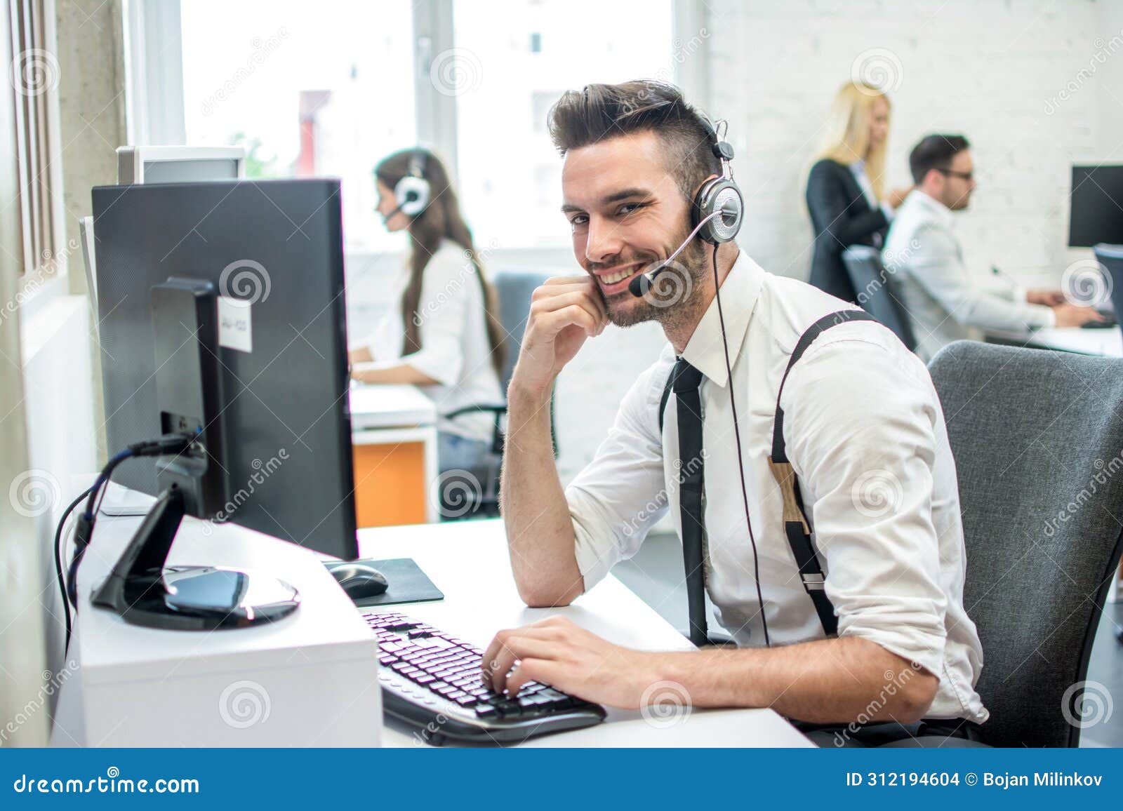 Handsome Smiling Young Call Center Agent Speaking with Costumer in Call ...