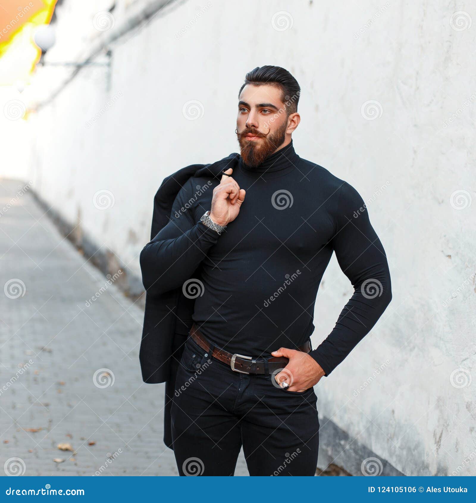 Handsome Strong Man with a Beard in Black Stylish Clothes Posing Stock ...