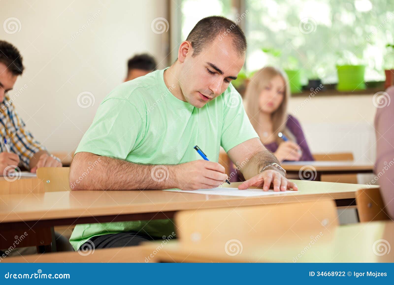 Handsome Student in a Classroom Stock Photo - Image of exam, horizontal ...