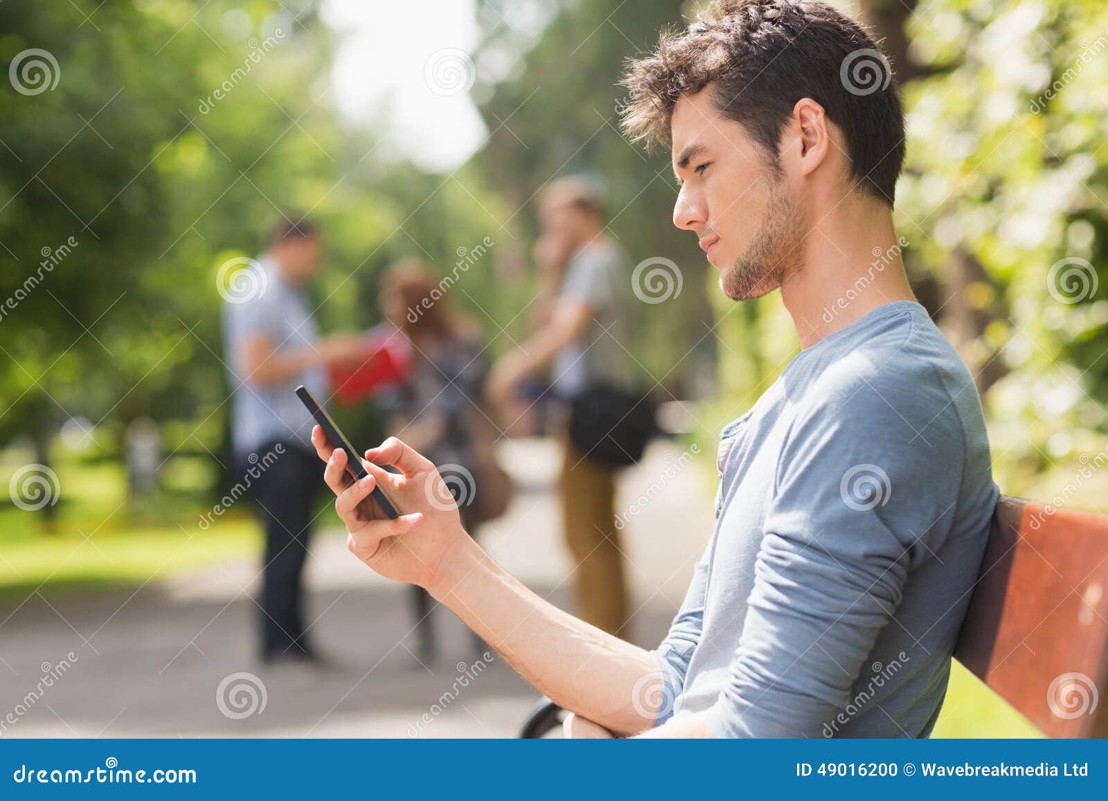 Handsome Student Sending a Text Outside Stock Photo - Image of ...