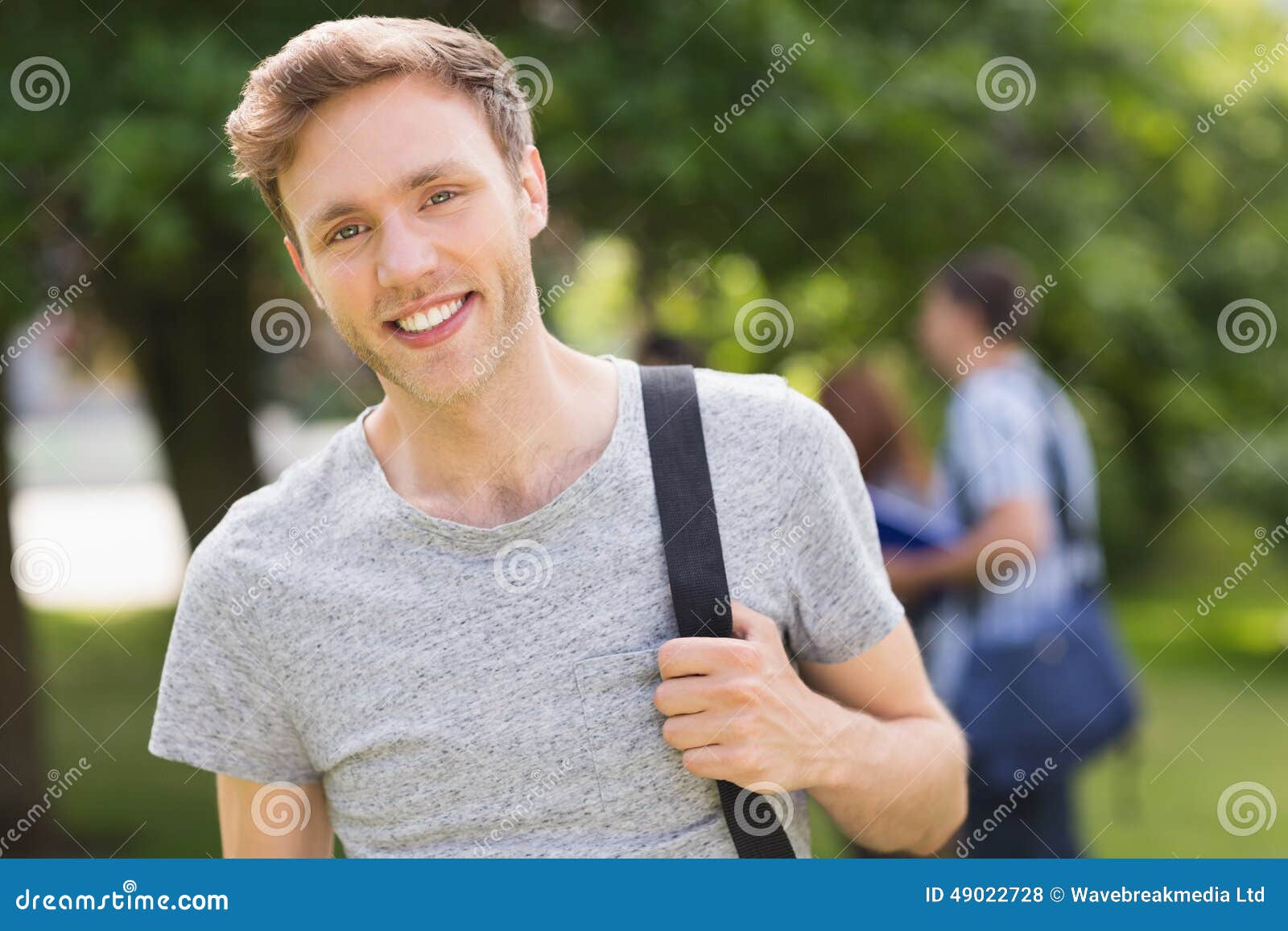 Handsome Student Smiling at Camera Outside on Campus Stock Photo ...