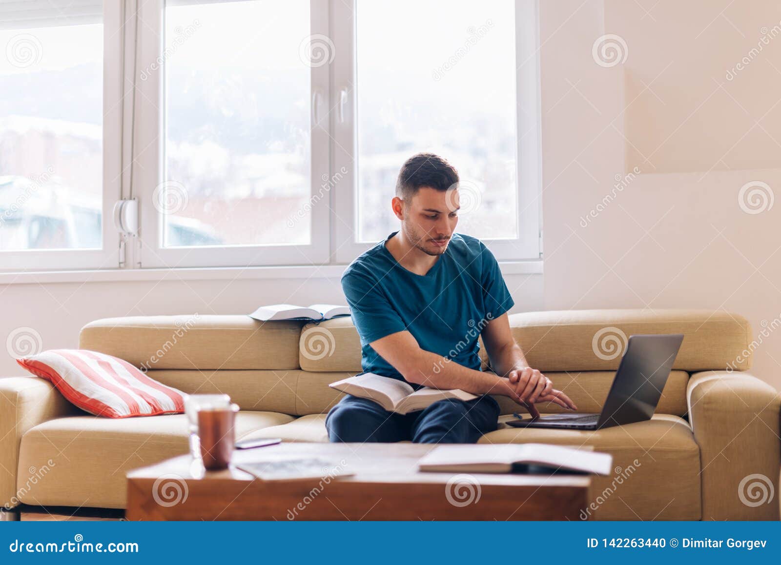 Handsome Student Studying on the Couch with Few Opened Books and a ...