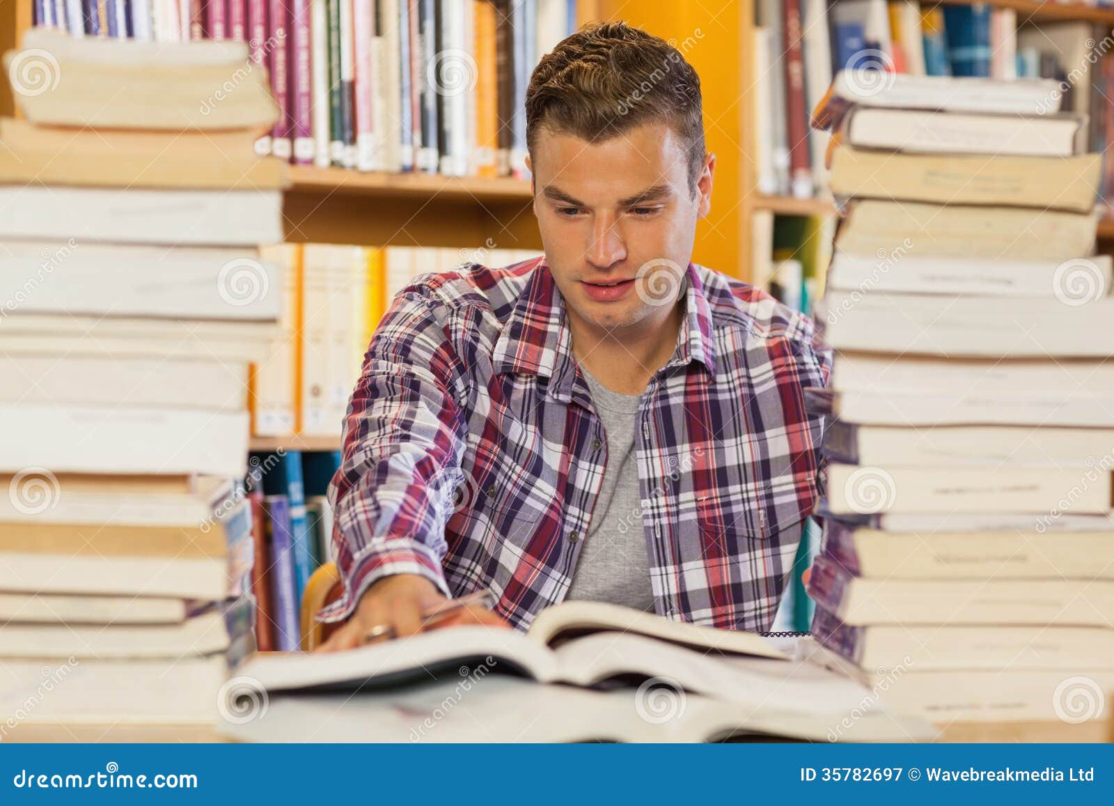 Handsome Student Studying between Piles of Books Stock Image - Image of ...