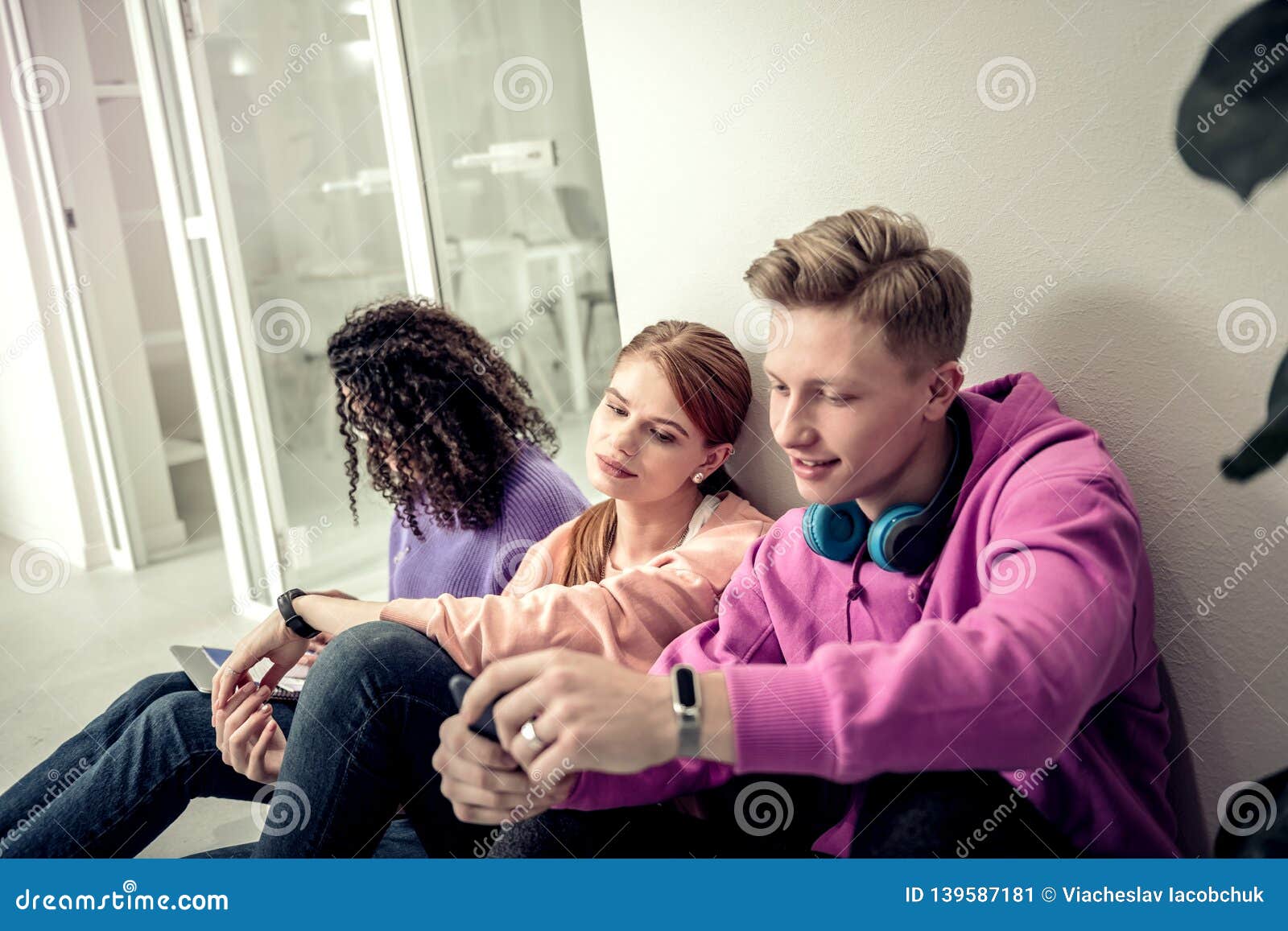 Handsome Student Wearing Smart Watch Using His Smartphone Stock Image ...