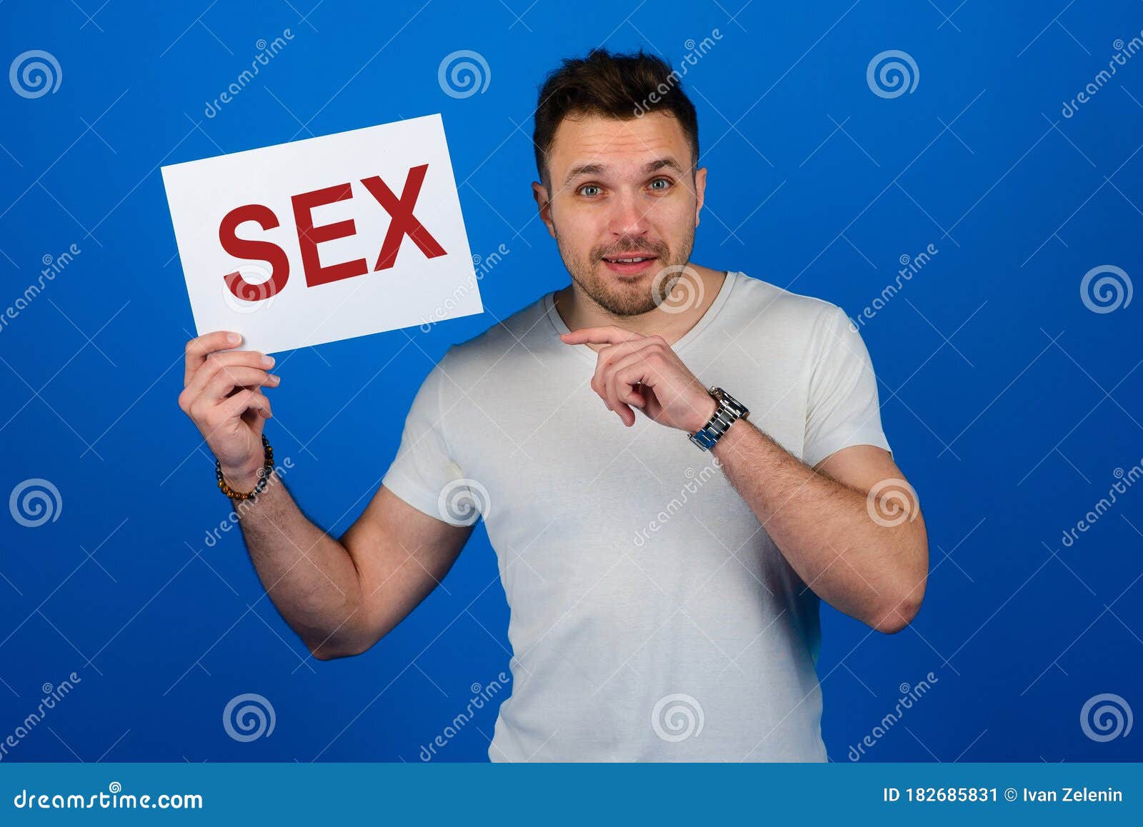 Handsome Stylish Man Standing with a Sign in His Hand in the Studio on ...