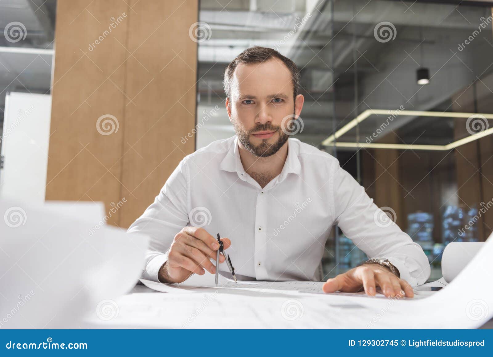 Handsome Successful Architect with Compass Working on Building Plans ...