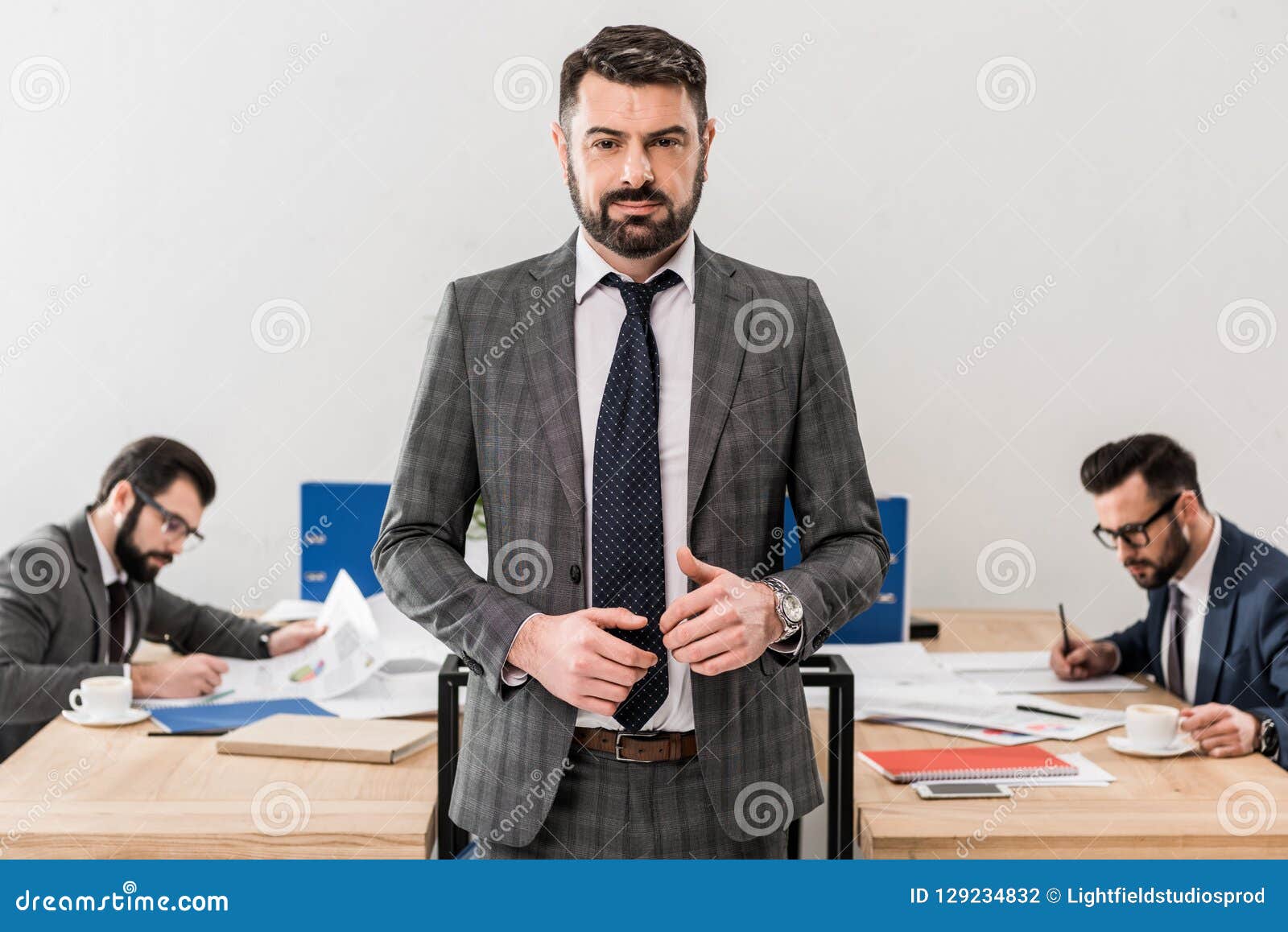 Handsome Team Leader Standing in Front of Workers and Looking Stock ...