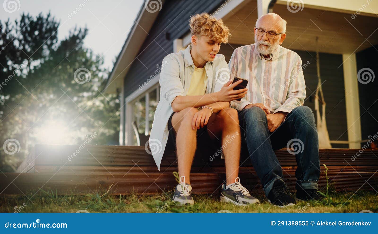 Handsome Teenage Grandson Teaching His Grandfather To Use a Smartphone ... Handsome Teenage Grandson Teaching His Grandfather To Use a Smartphone ...