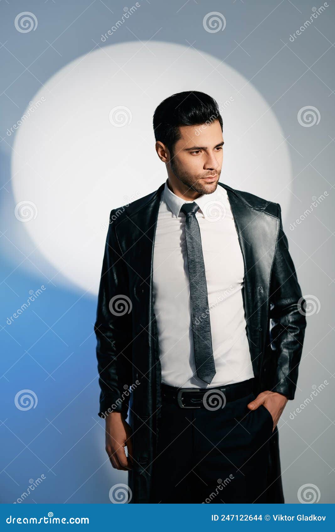 Handsome Trendy Man Posing in the Spotlight on Studio Background Stock ...