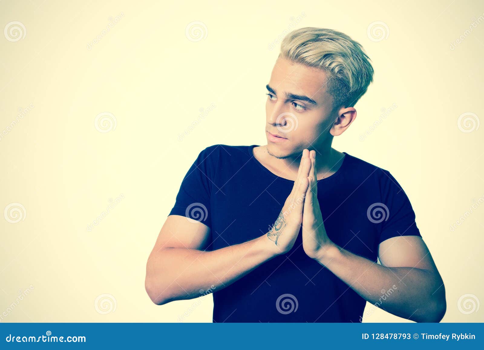 Handsome Trendy Pensive Young Guy Folded His Hands As he Asks for ...
