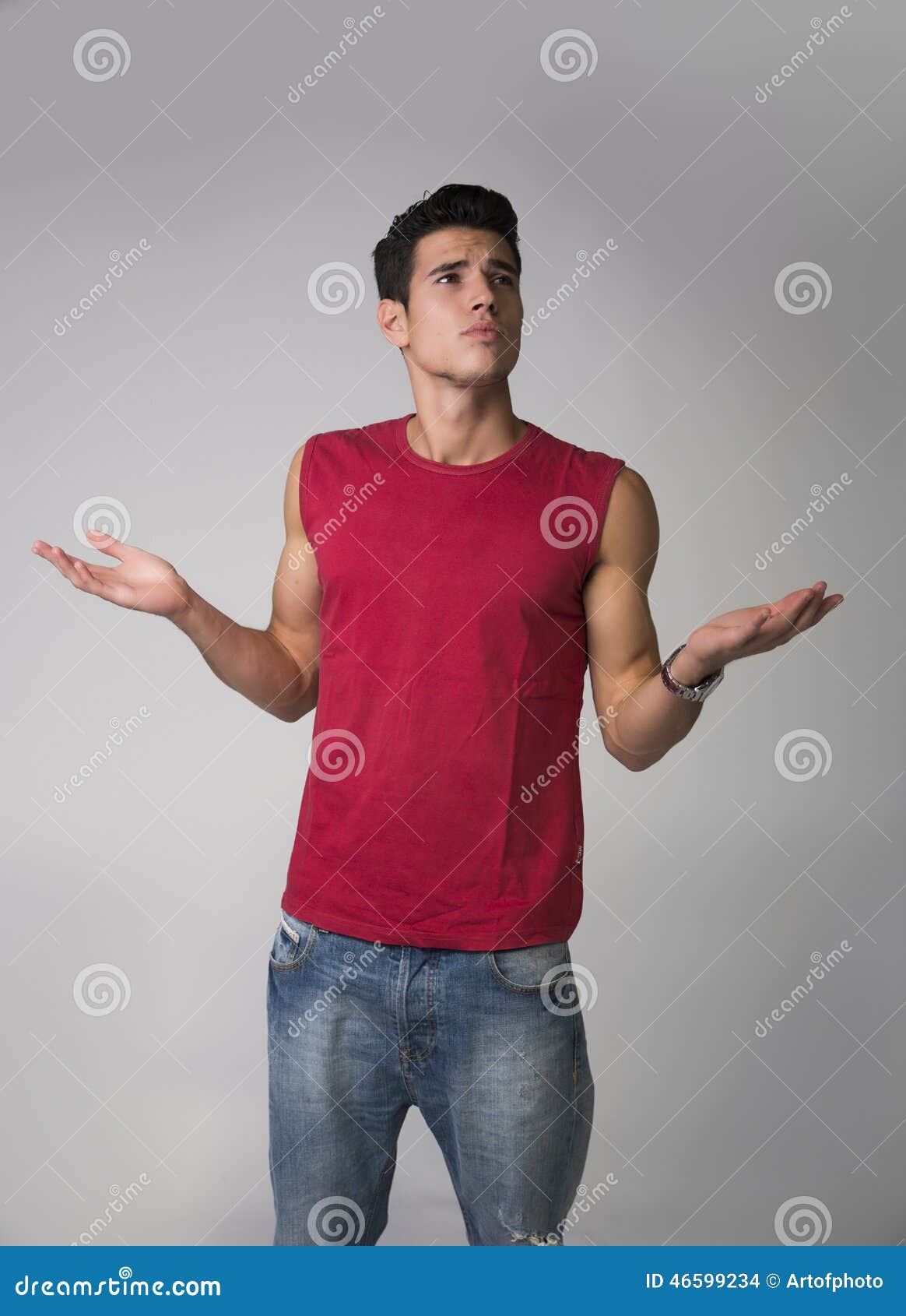 Handsome Unsure, Doubtful Young Man Shrugging with Arms Open Stock ...