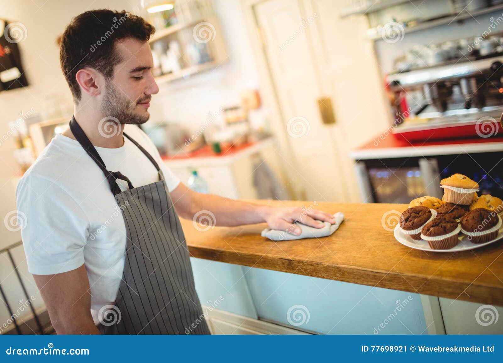 Waiter Cleaning The Table With Spray Disinfectant In Cafe. Stock Image ...