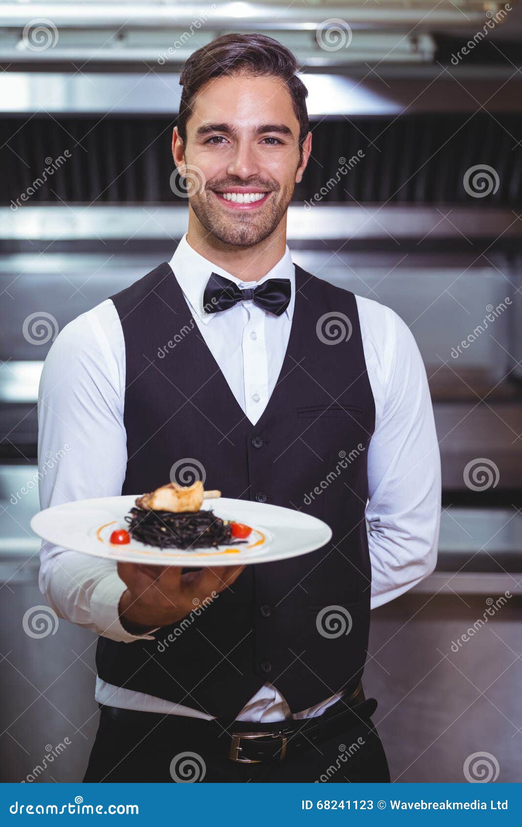 Handsome Waiter Holding a Plate of Squid Ink Spaghetti Stock Image ...