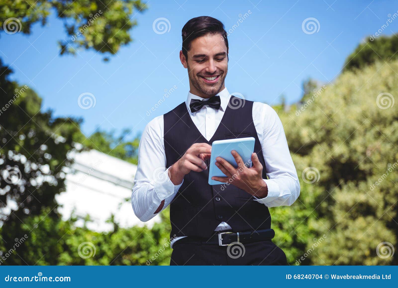 Handsome Waiter Using Tablet Computer Stock Photo - Image of bright ...