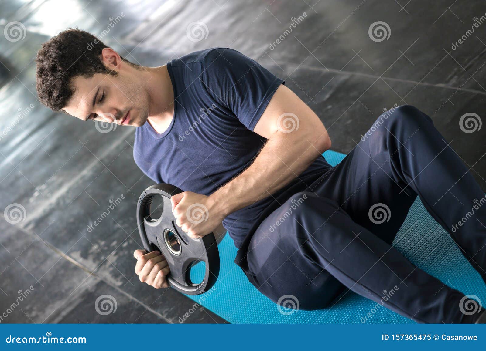 Handsome Weightlifter Lifting Plates Dumbbell in Gym Exercise with Work ...
