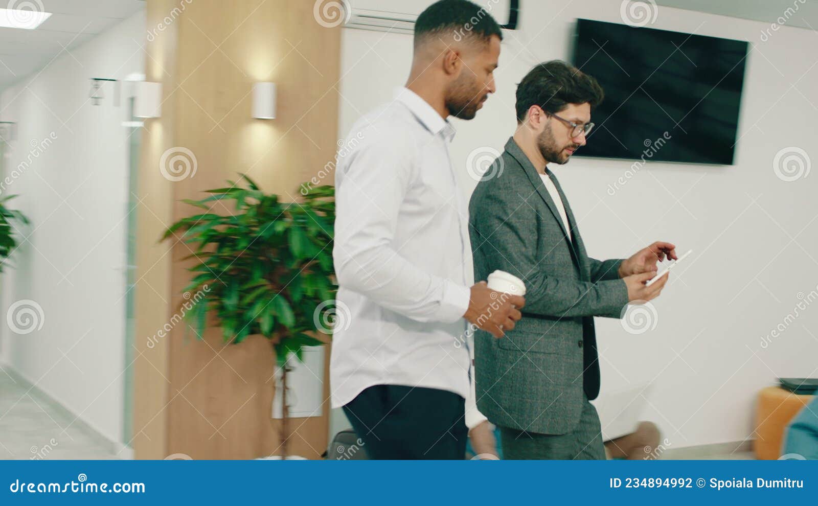 A Handsome White Man with a Beard in a Black Suit is Walking with His ...