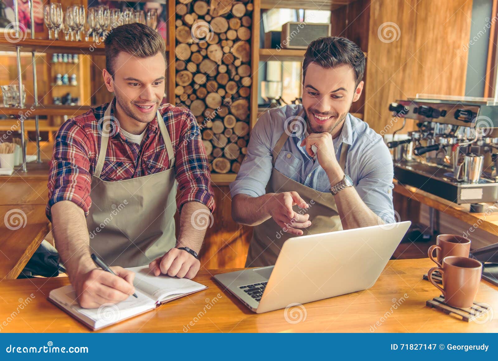 Handsome workers at cafe stock image. Image of notes - 71827147