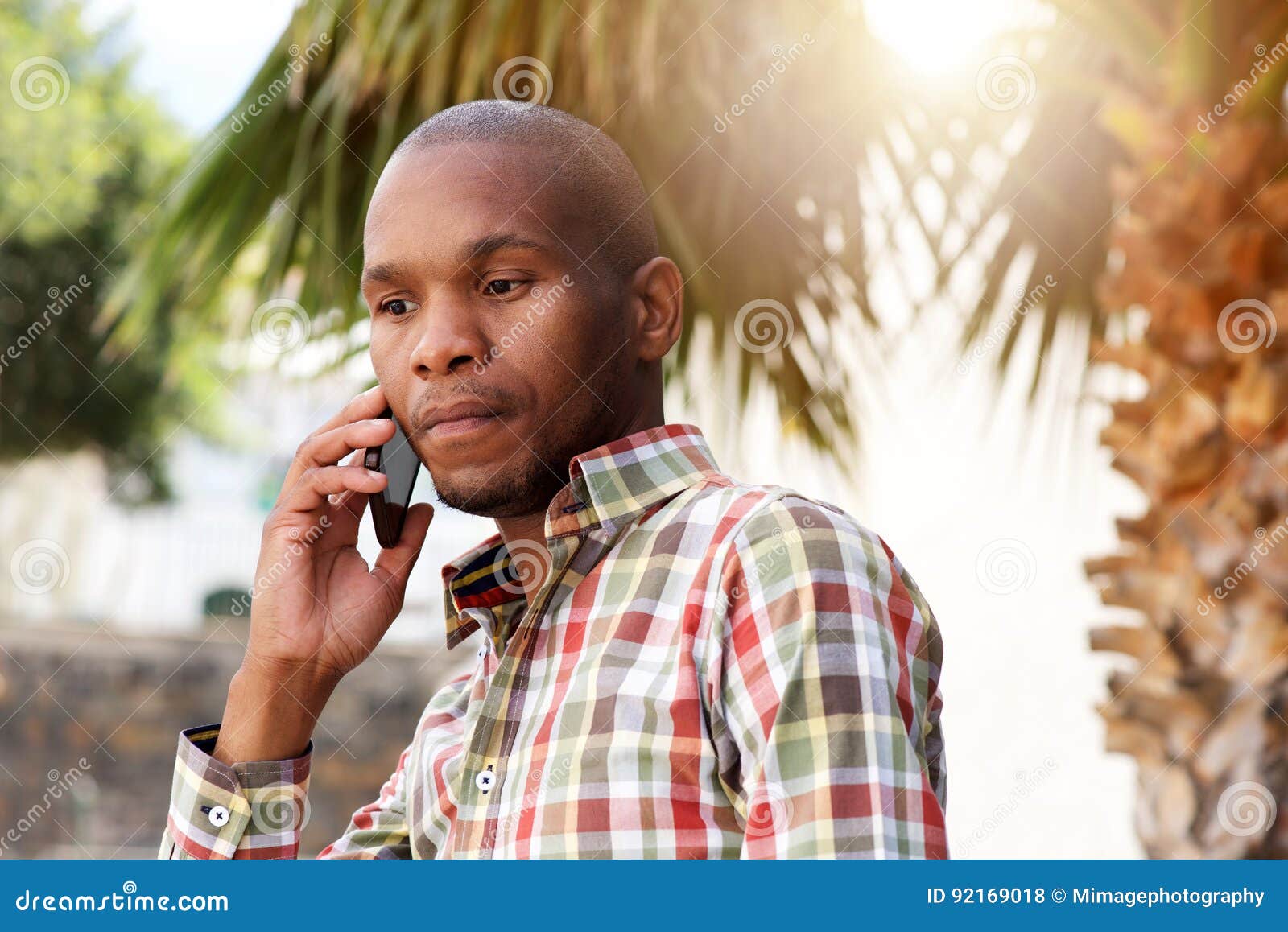 Handsome Young African Man Talking on Mobile Phone Outside Stock Photo ...