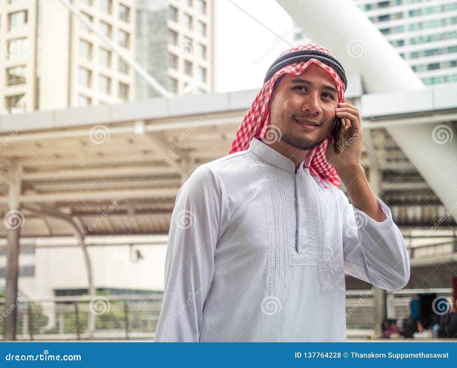 Handsome Young Arabic Male Texting on a Mobile Phone Stock Photo ...