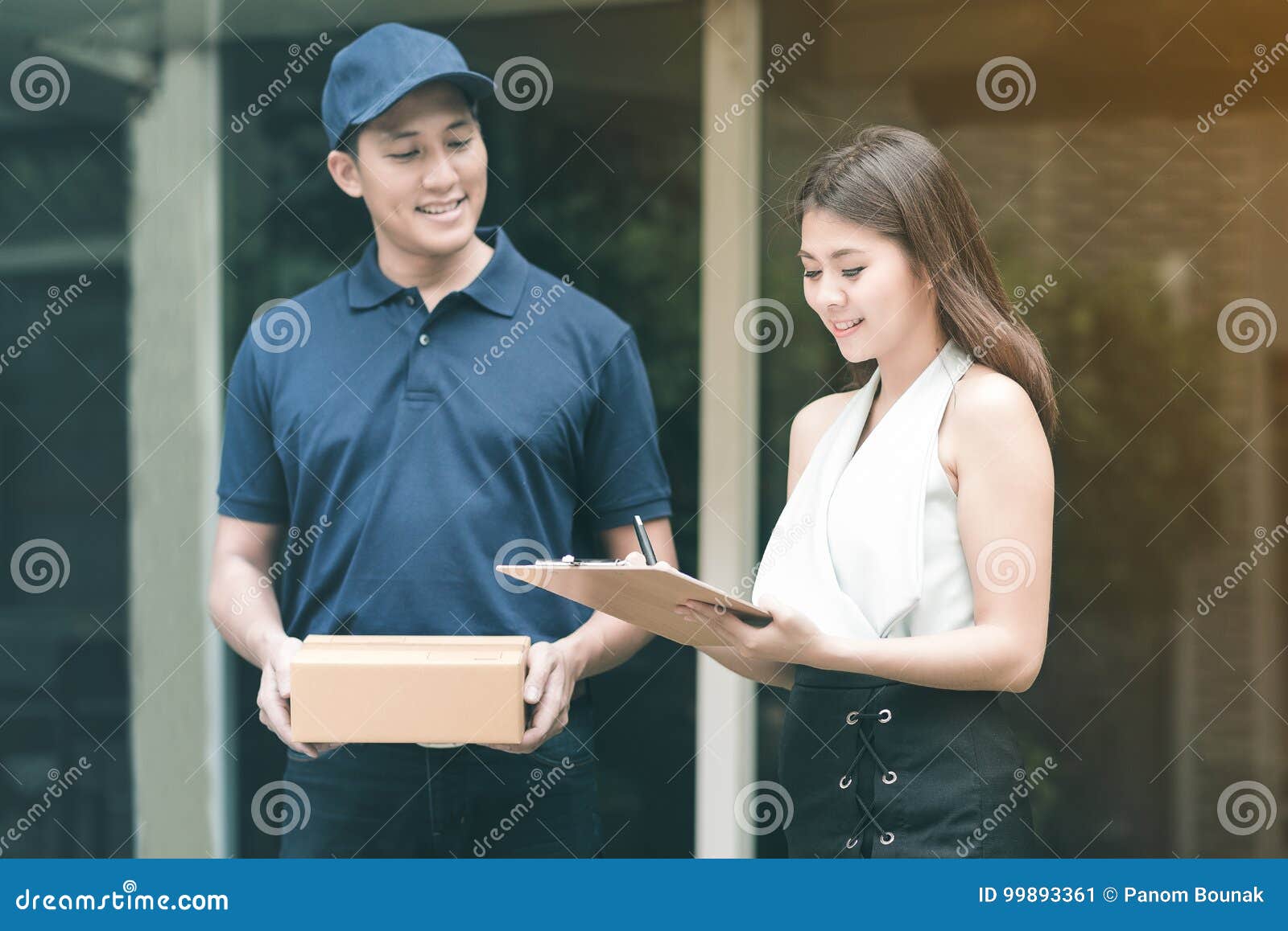 Handsome Young Asian Delivery Man Smiling and Holding a Cardboard Box ... Handsome Young Asian Delivery Man Smiling and Holding a Cardboard Box ...