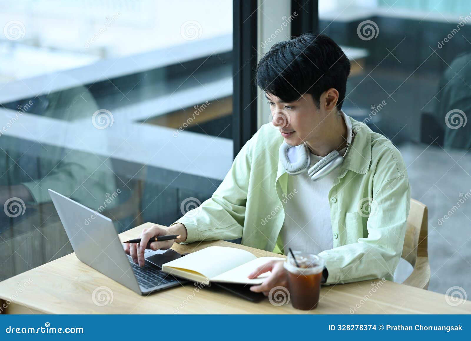 Handsome Young Asian Man Using Laptop and Making Note. People ...