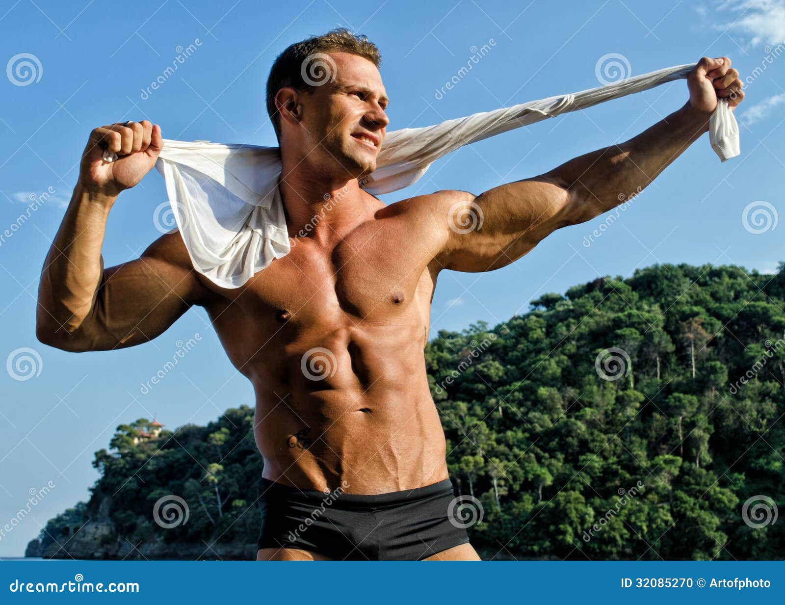 Handsome Young Bodybuilder with Arms Open in Nature Setting Stock Photo ...