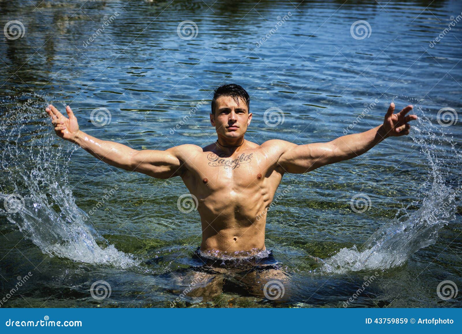 Handsome Young Bodybuilder In The Sea Splashing Water Up Stock Image