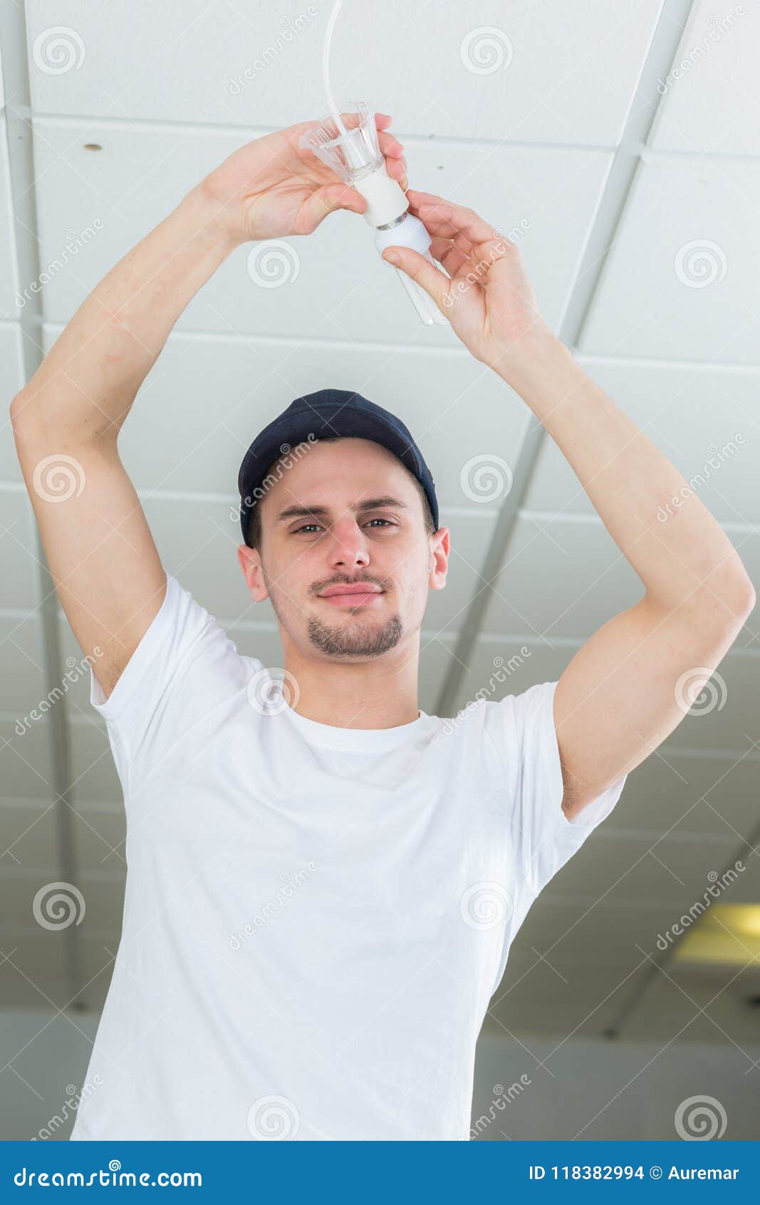 Handsome Young Builder Installing Light Bulb Indoors Stock Photo ...