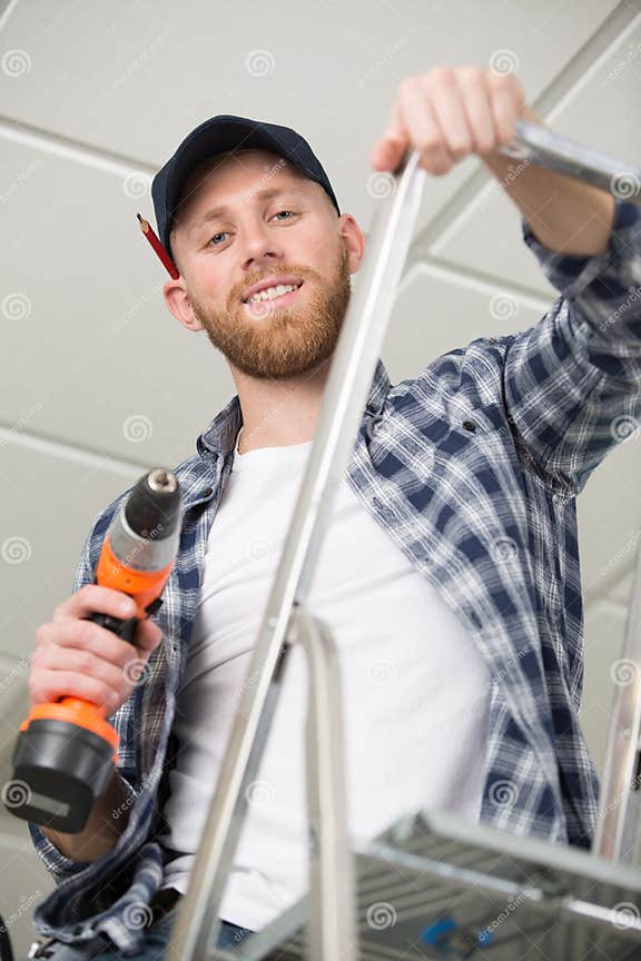 Handsome Young Builder Installing Light on Ceiling Stock Image - Image ...