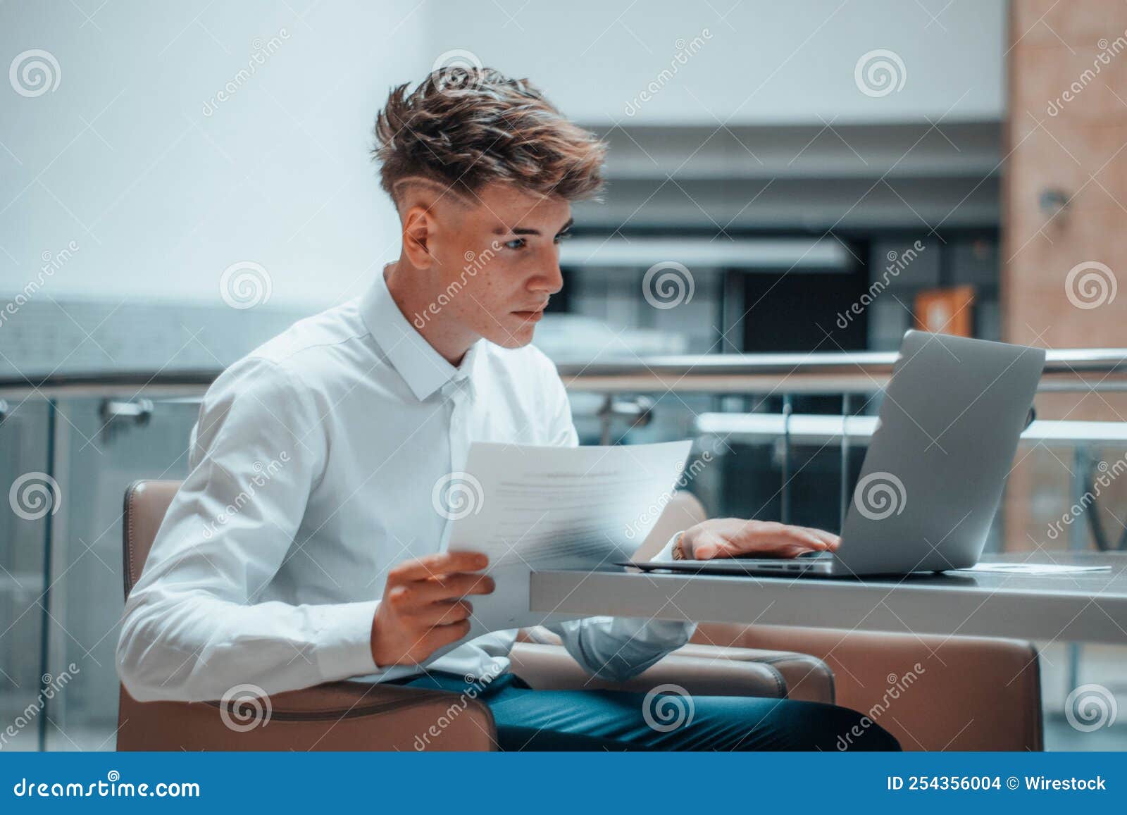 Handsome Young Business Boy Working on a Laptop in the Office Stock ...