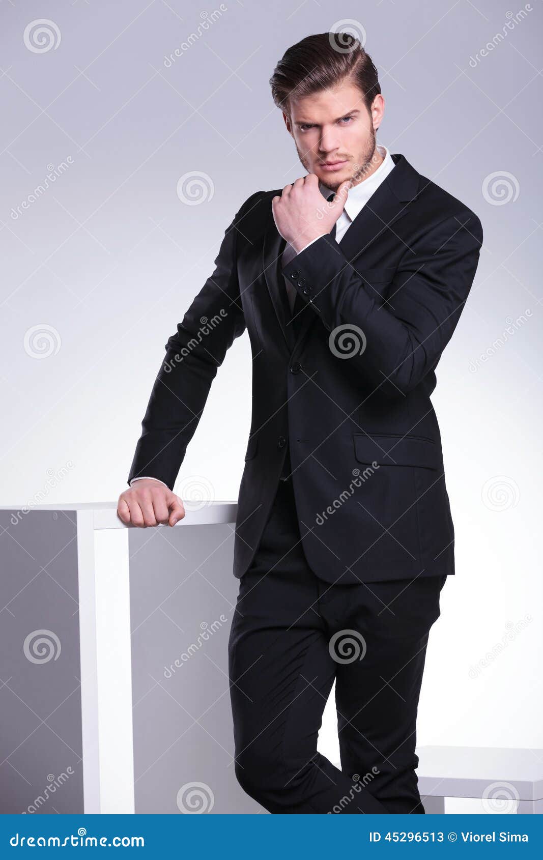 Handsome Young Business Man Leaning on a White Table Stock Image ...