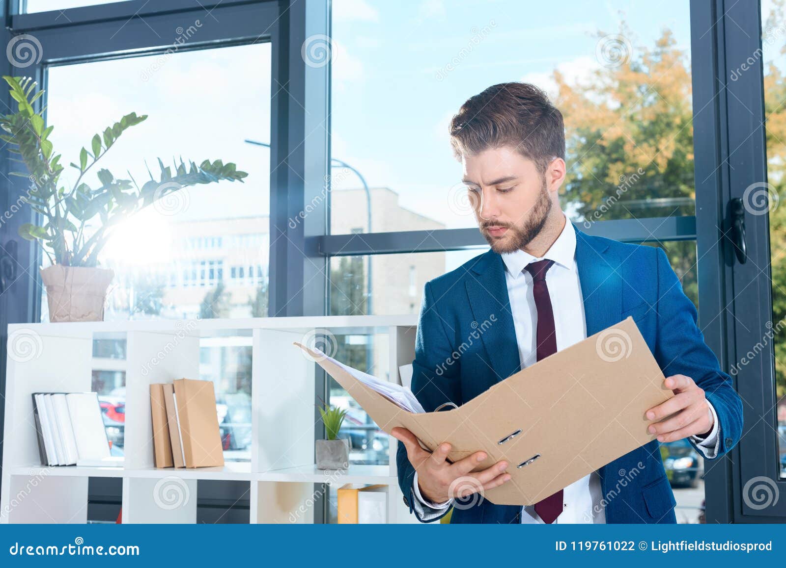 Handsome Young Businessman Holding Folder Stock Photo - Image of ...