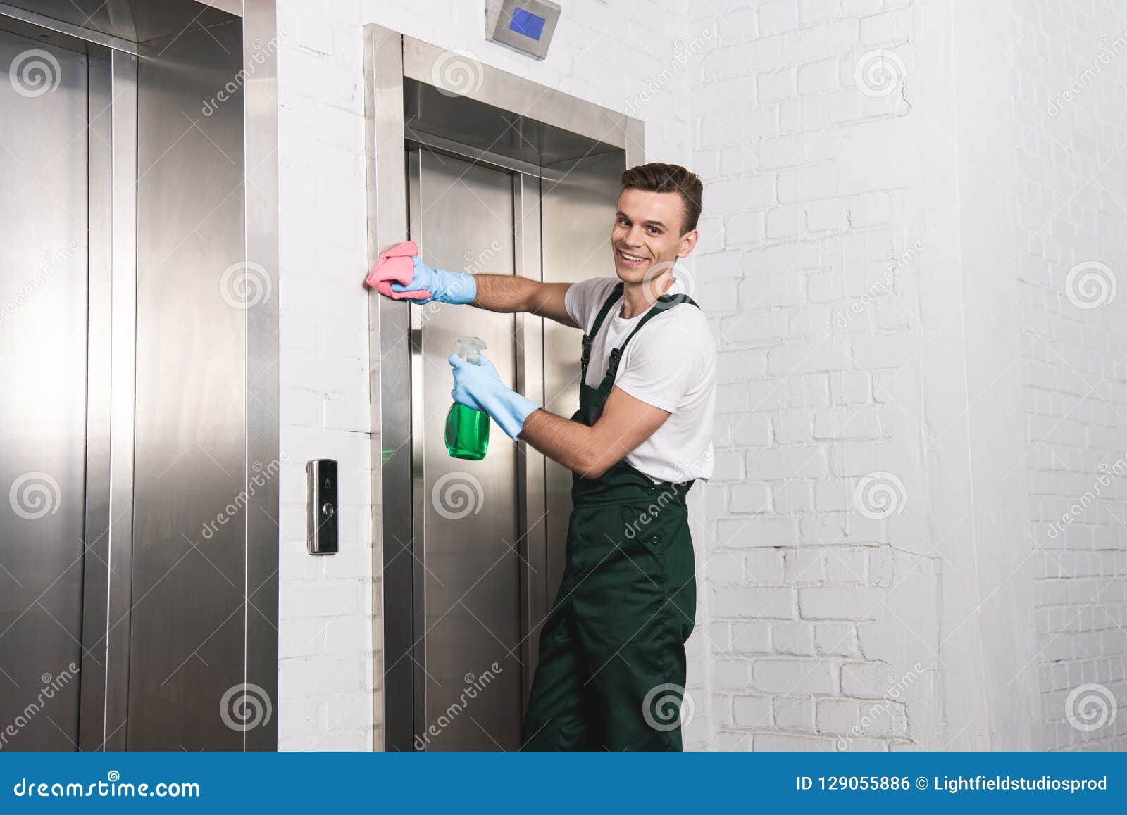 Handsome Young Cleaner Washing Elevator and Smiling Stock Photo - Image ...