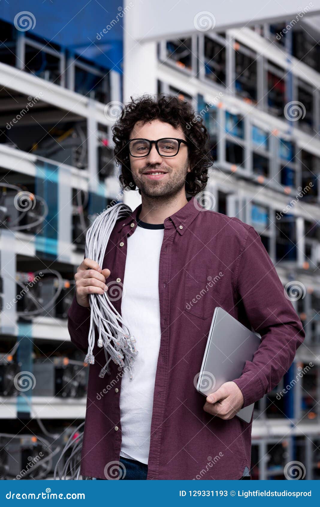 Handsome Young Computer Engineer with Laptop and Wires Working at ...