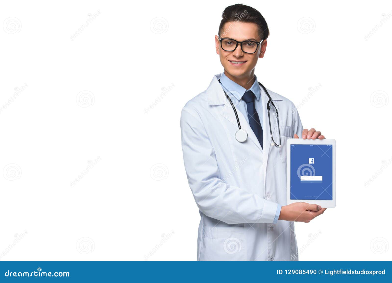 Handsome Young Doctor Holding Tablet with Facebook App on Screen ...