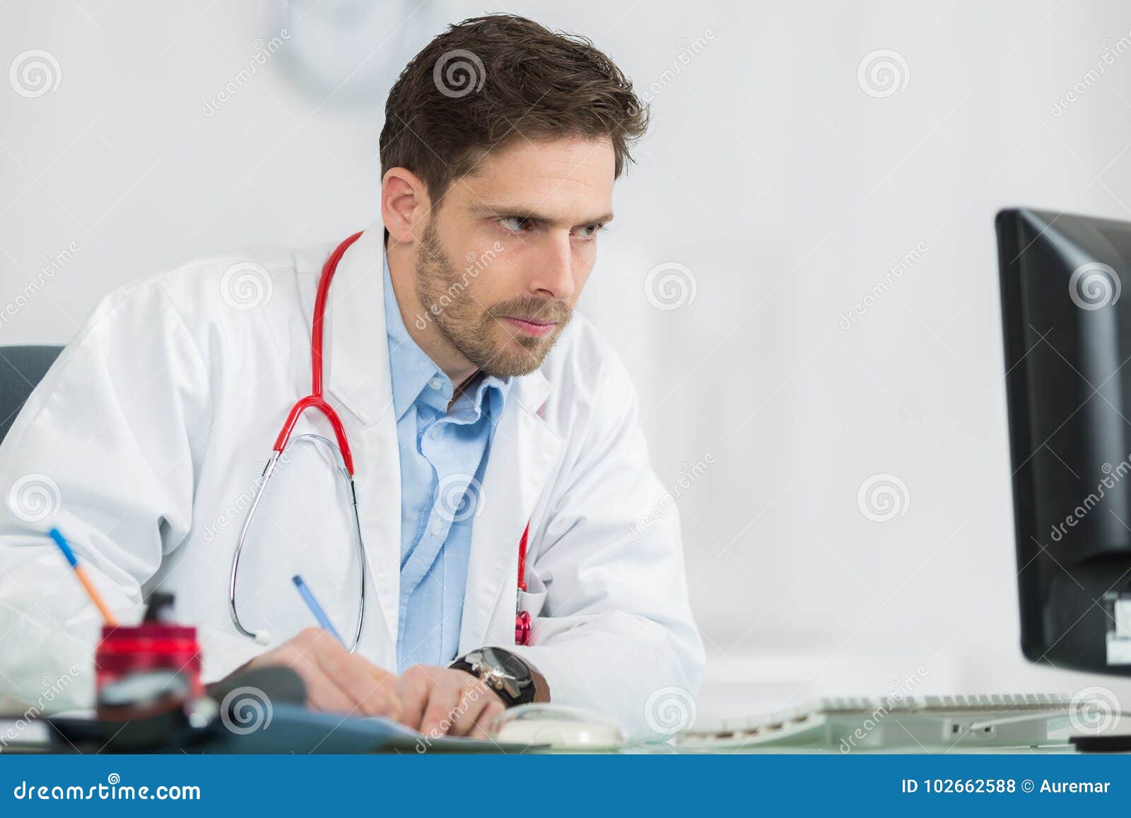Handsome Young Doctor at Work in Office Stock Photo - Image of ...