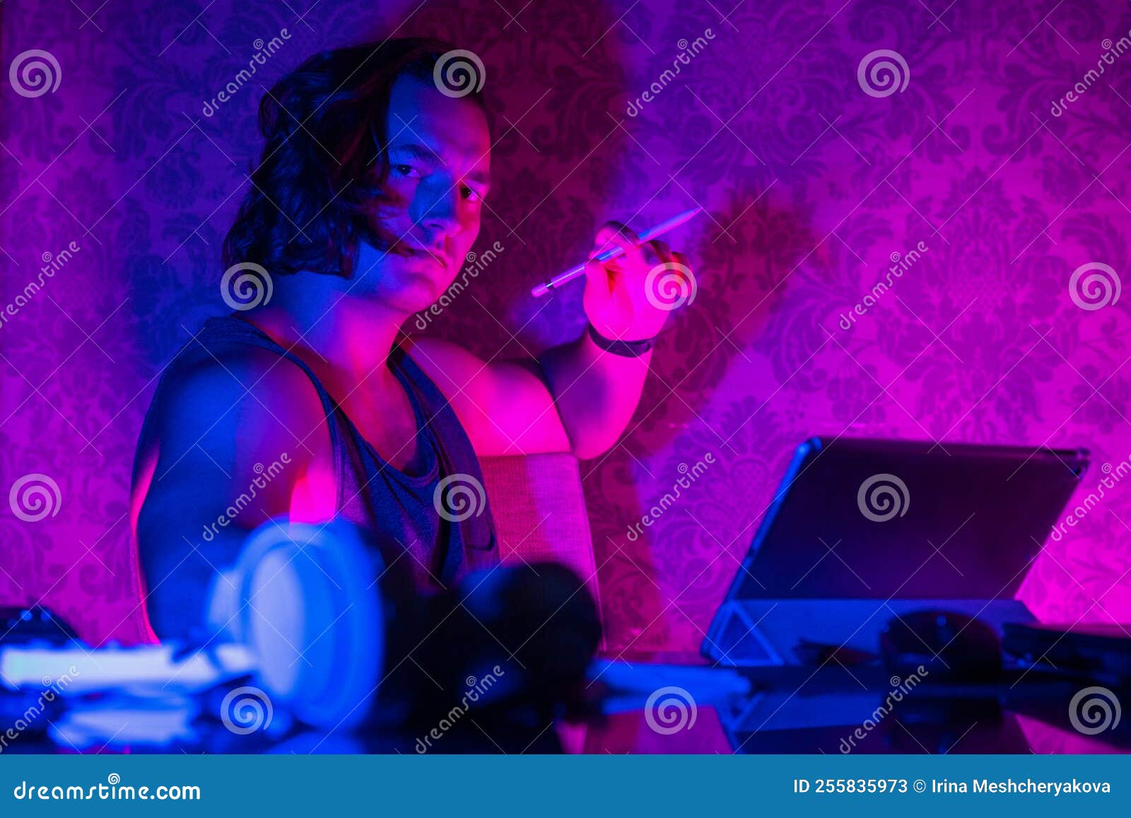 Young Guy with Digital Pencil, Room is Illuminated by Violet Light ...