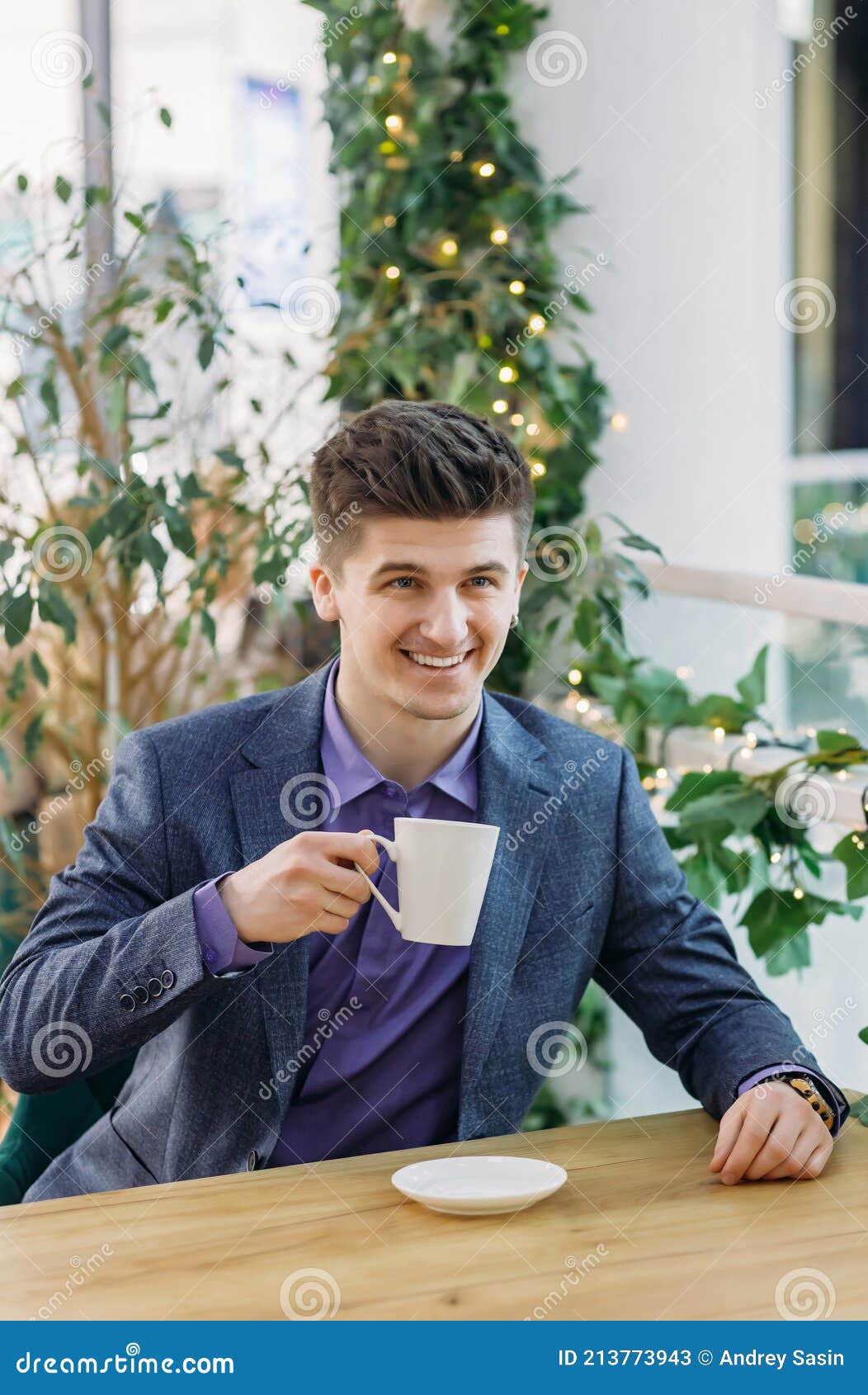 Handsome Young Guy in a Suit is Drinking Coffee and Smiling for the ...