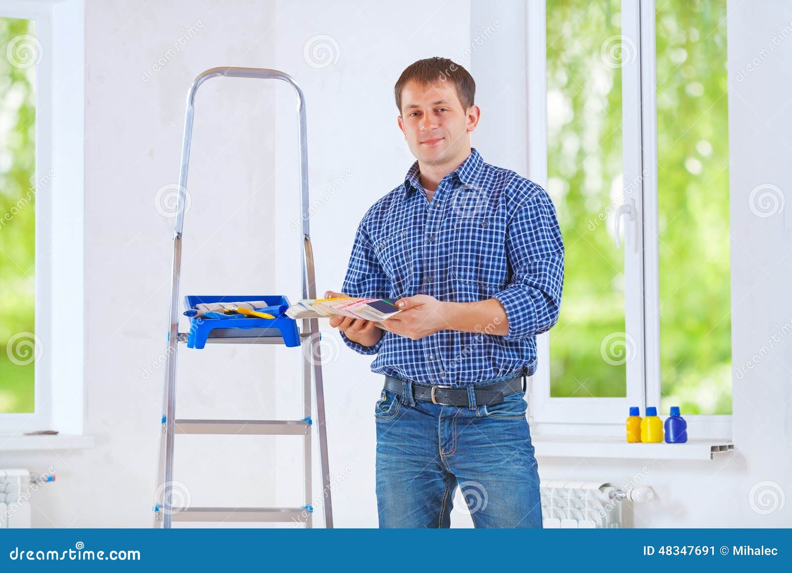 Handsome Young Homeowner Holding Color Palette and Looking at Ca Stock ...