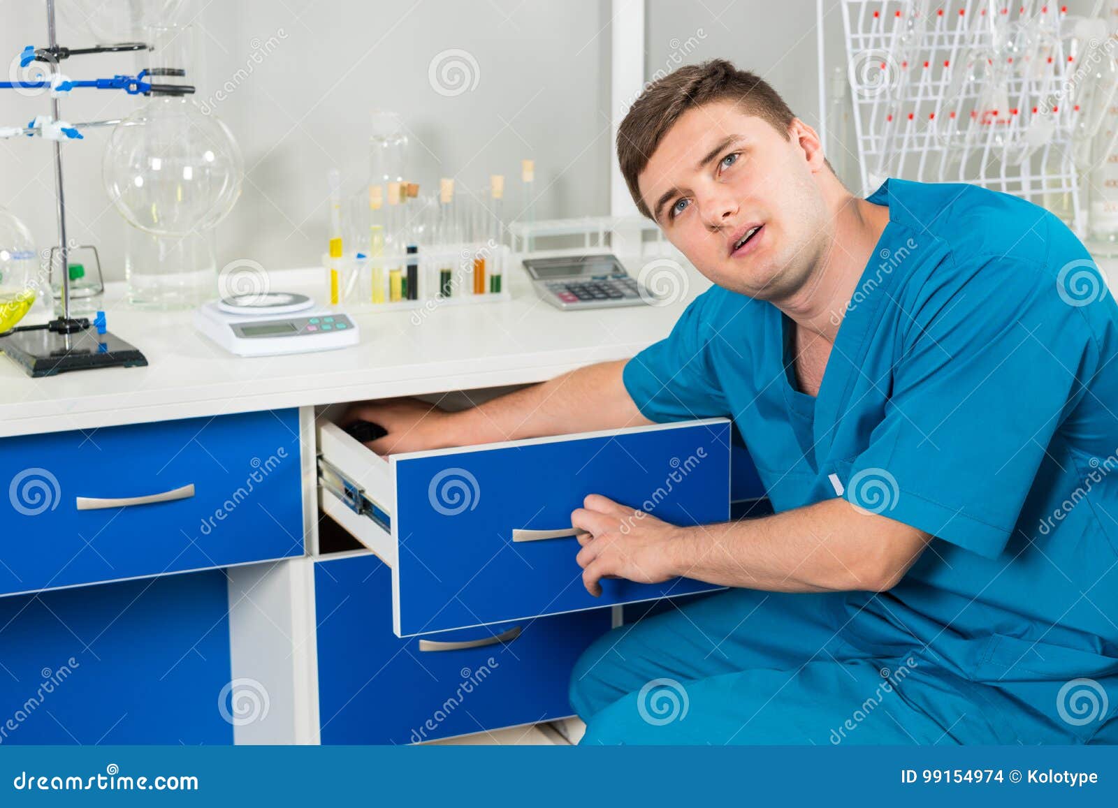 Handsome Young Lab Assistant is Looking for Something in a Cases Stock ...